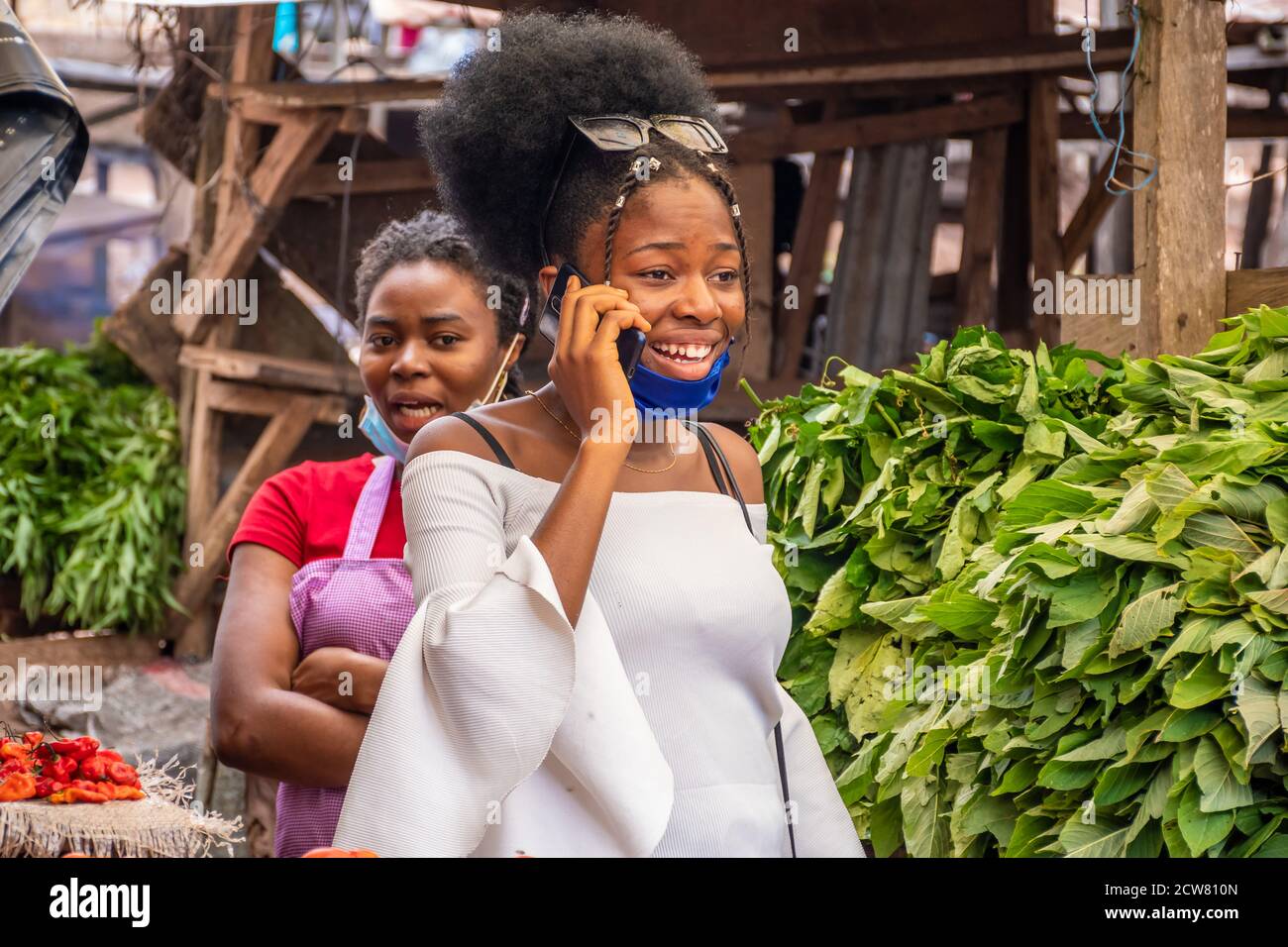 african woman making a phone call in a local market Stock Photo - Alamy
