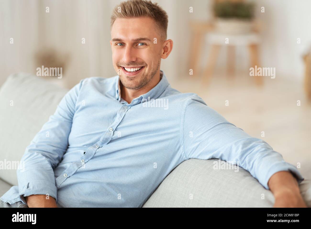 Guy having rest at home on his couch Stock Photo - Alamy