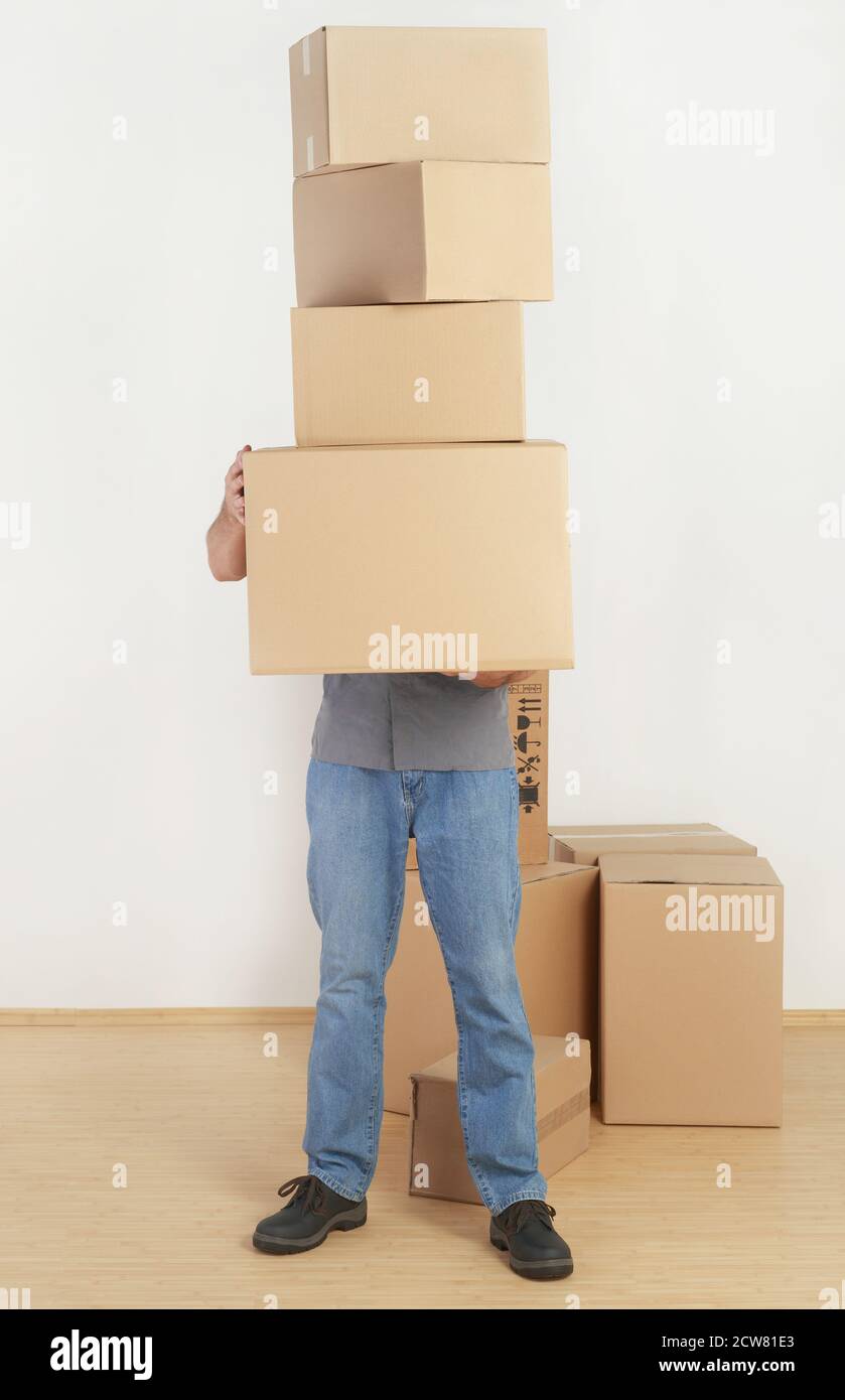 Man with moving boxes Stock Photo - Alamy
