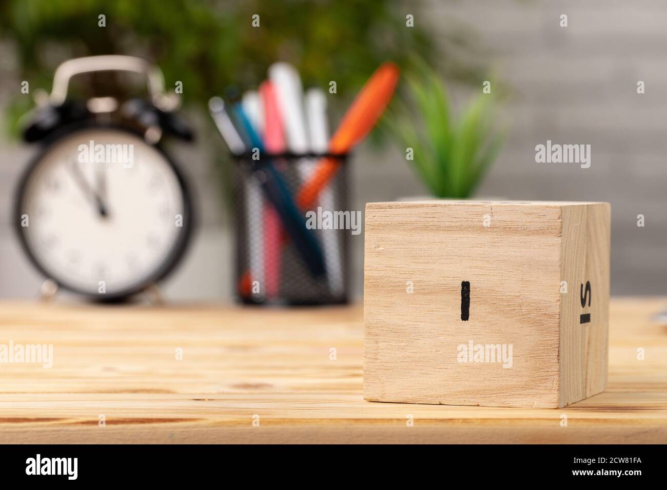 Wooden blocks and alarm clock on wooden desk Stock Photo - Alamy