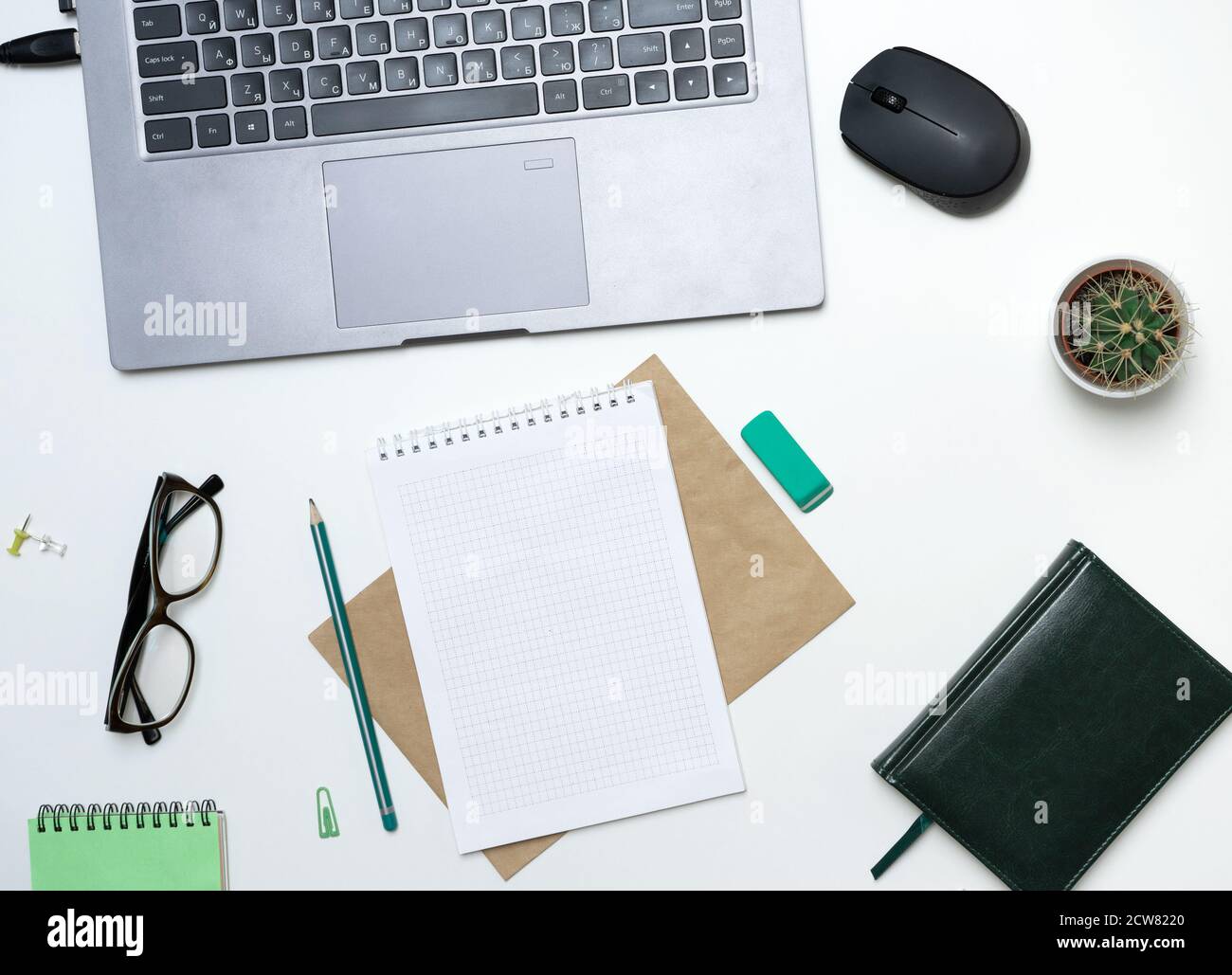 Office table with notepad, computer and notepad. View from above with ...