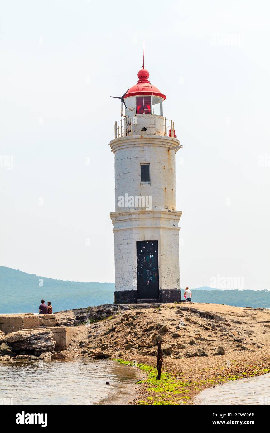 Vladivostok, Russia - July 30, 2015: People resting near the lighthouse ...