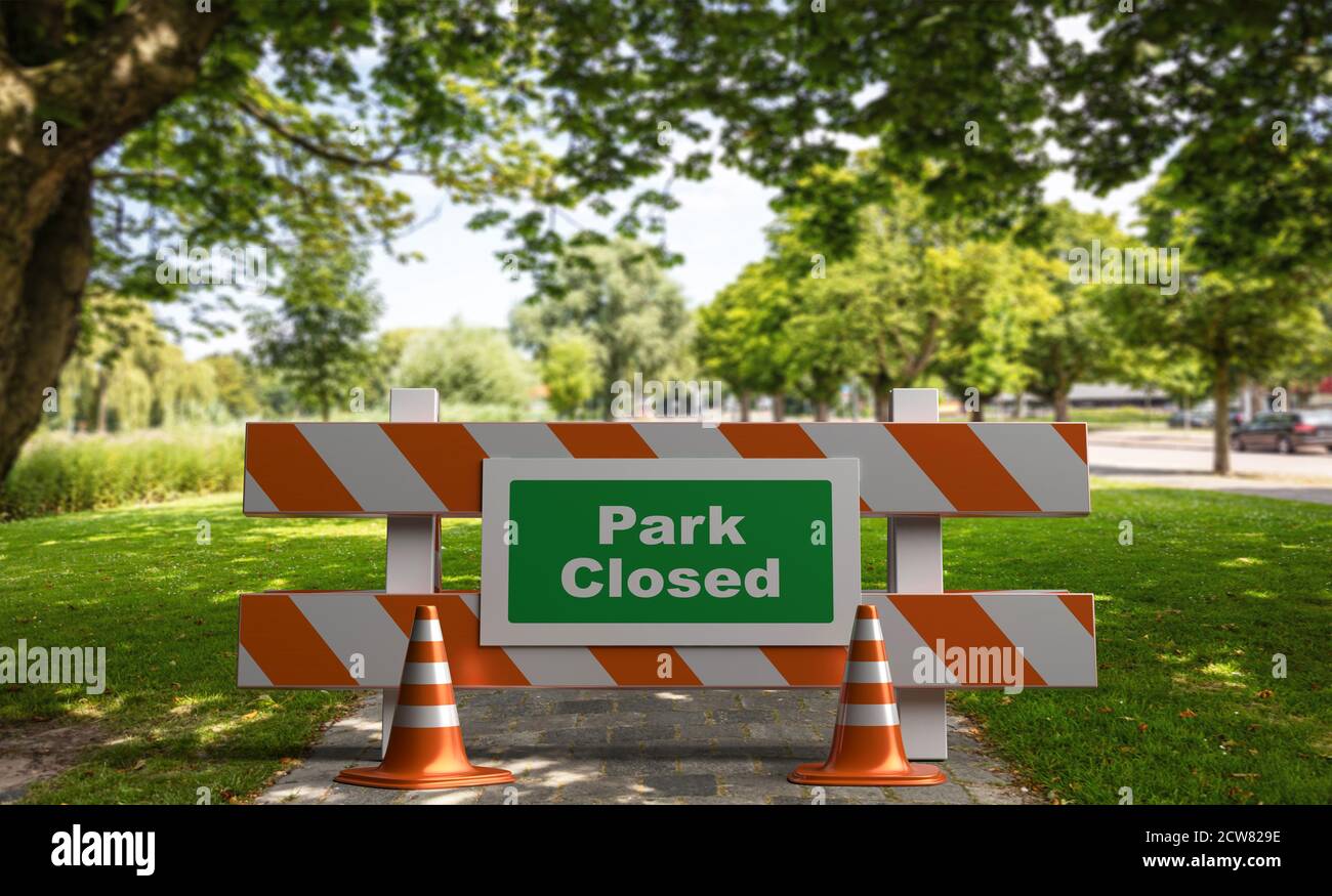 Closed park text sign, street barriers and traffic cones on empty green ...