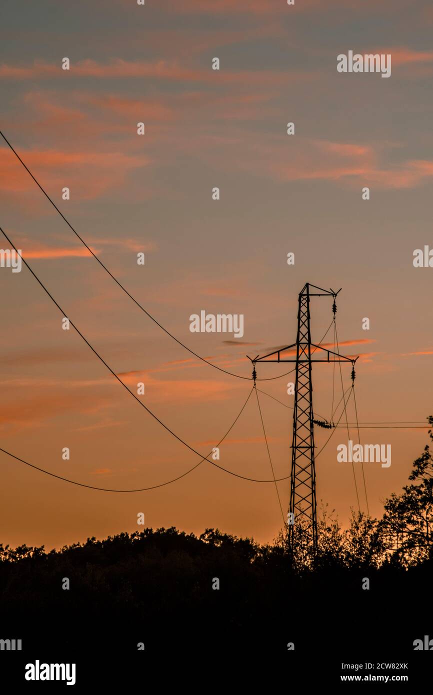 Electric pole at sunset. Golden hour. Orange sky with clouds. Power ...