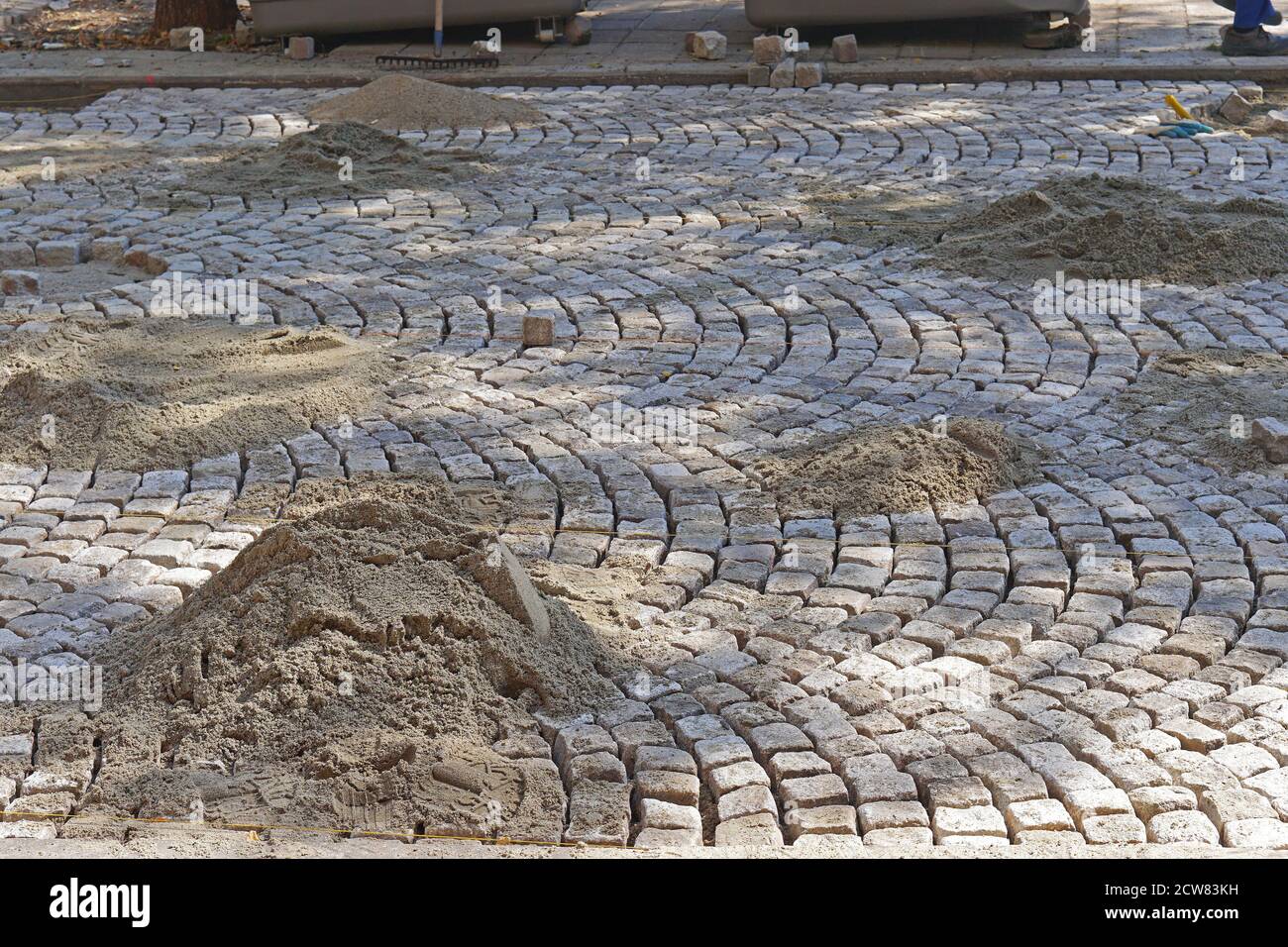 Old style laying cobblestone street pavement Stock Photo - Alamy