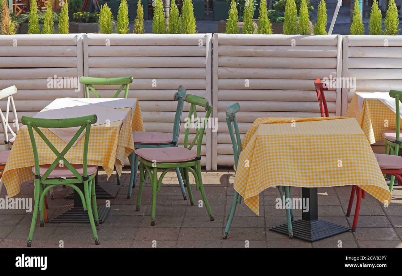 Cafe tables and chairs at city street outdoor Stock Photo - Alamy
