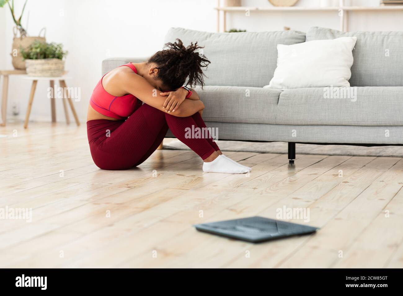 Young overweight woman scales hi-res stock photography and images - Alamy