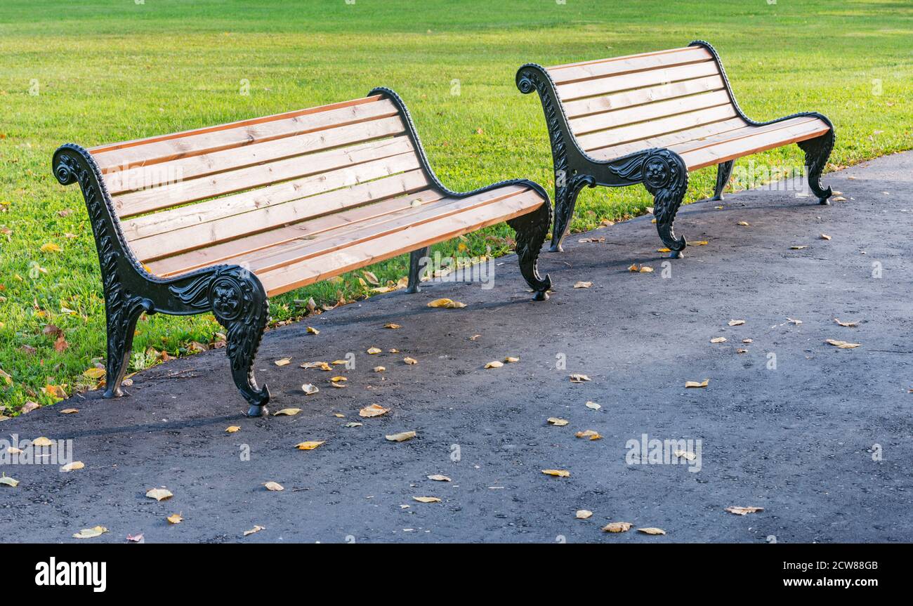 Wooden benches in the city park at sunset time Stock Photo - Alamy