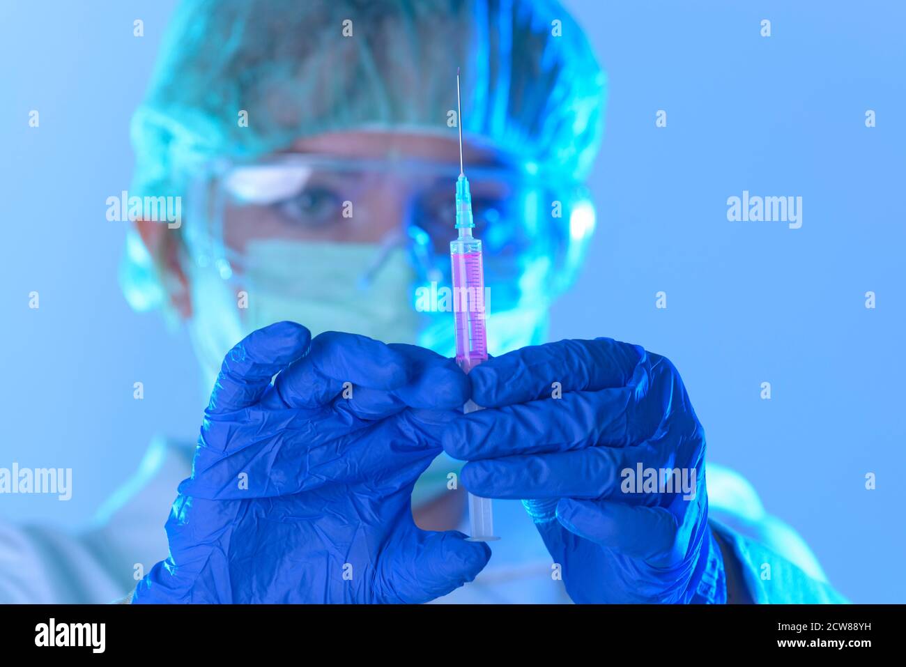 scientist working in a laboratory holding a syringe with a new anti ...