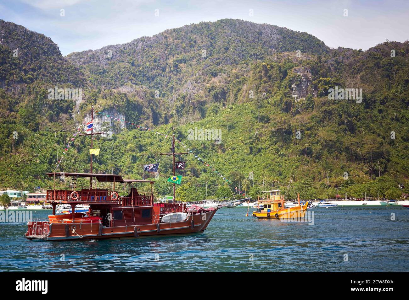 Modern pleasure tourist boat, stylized as a pirate ship. Against the ...