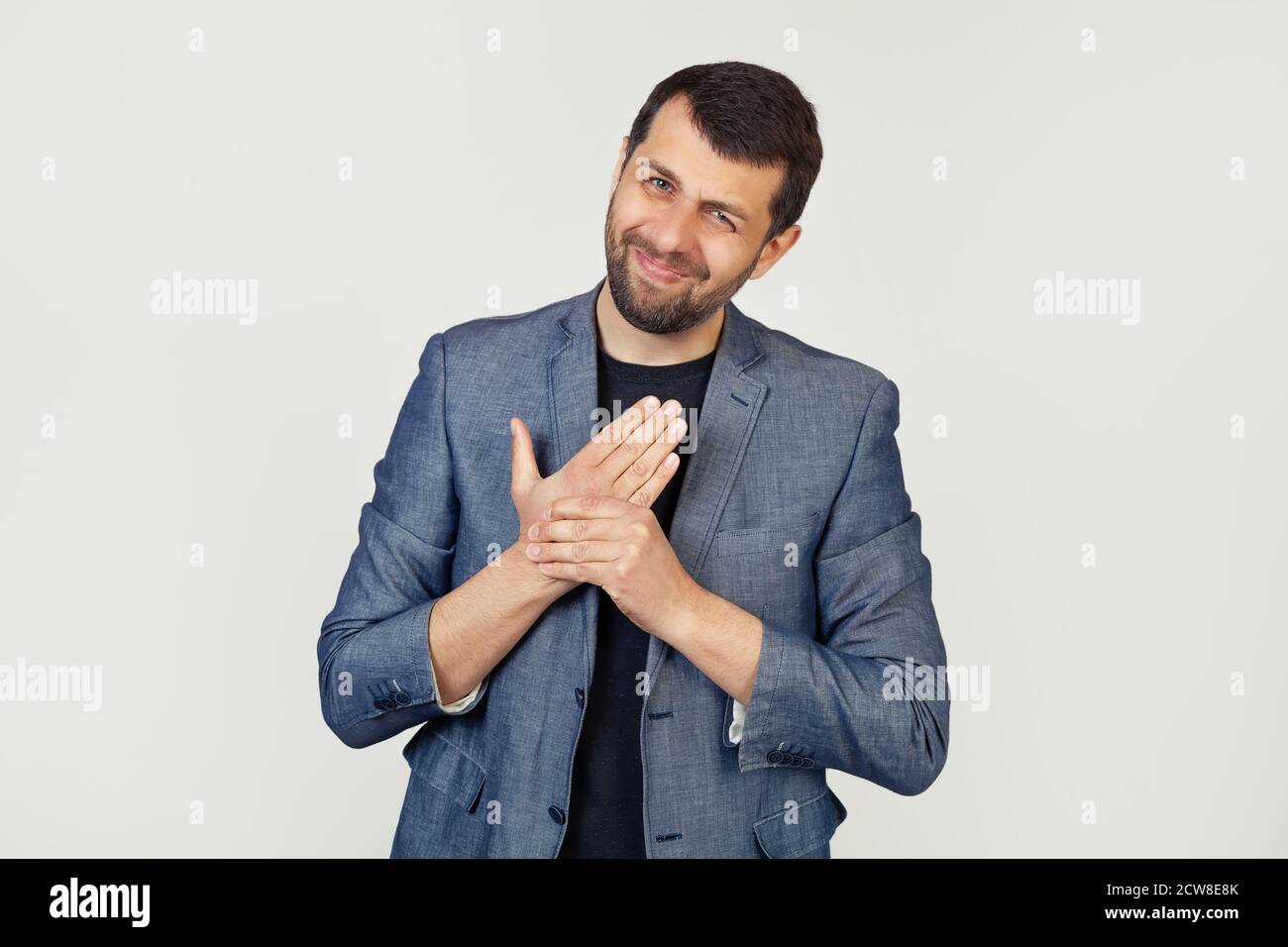 Young businessman man with a beard in a jacket, suffering from pain in ...