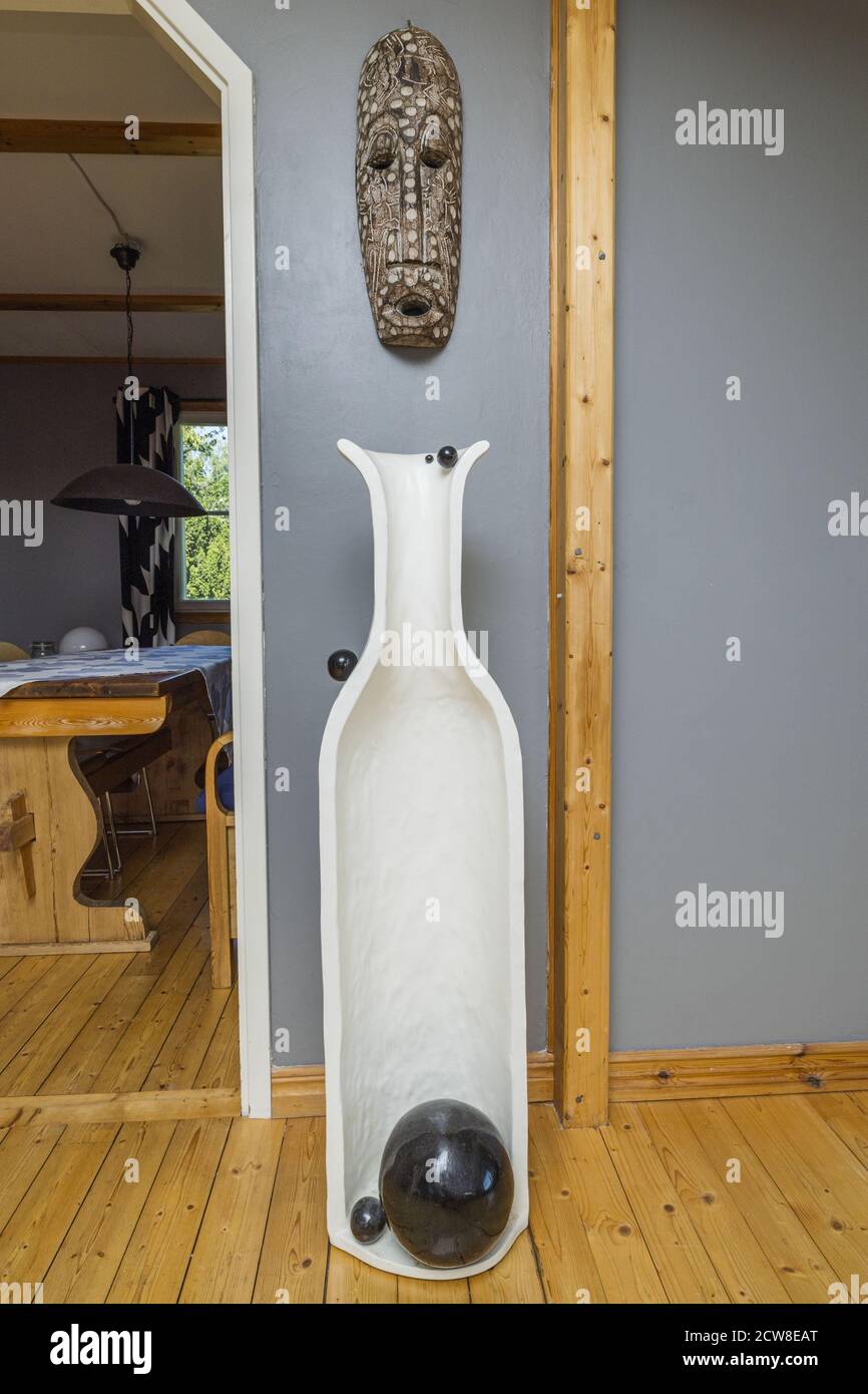 Close up view of cultural decorated grey wall . African wall mask ...