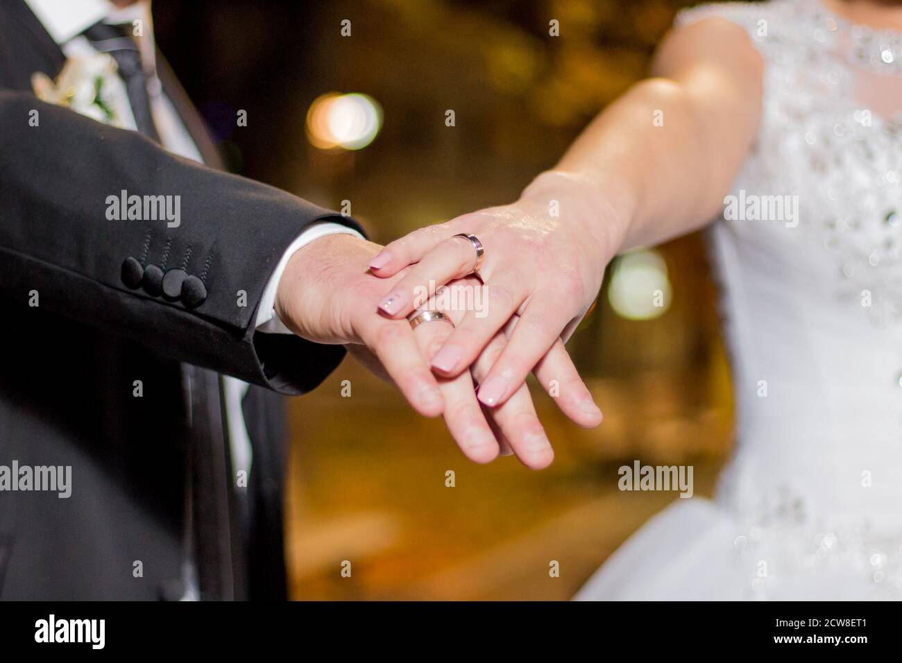 Bride and the groom holding hands at their wedding ceremony Stock Photo ...