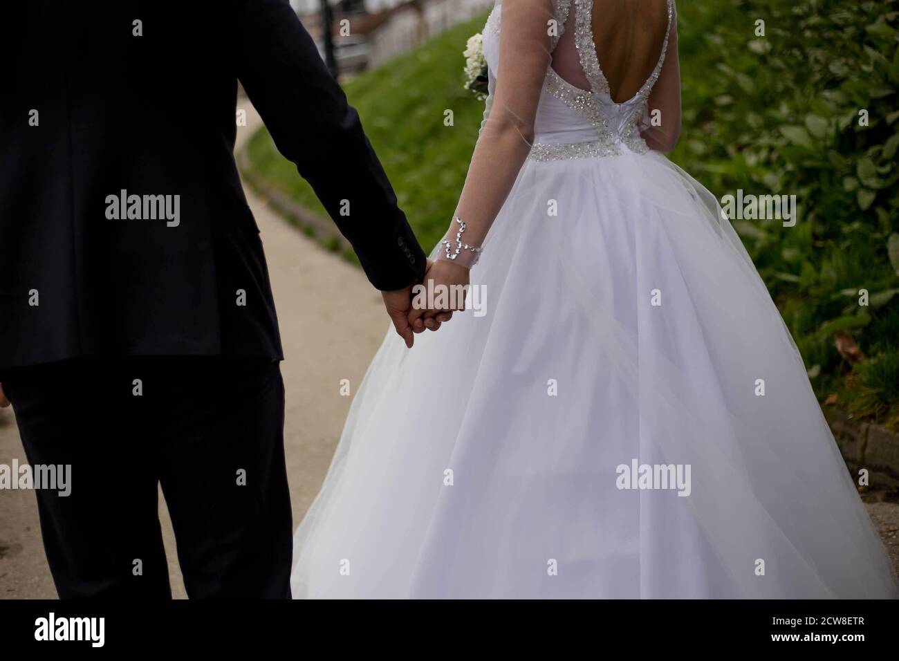 Bride and the groom holding hands at their wedding ceremony Stock Photo ...