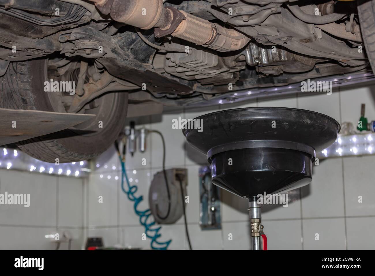 The old oil is drained from the car engine. Car maintenance. The car ...