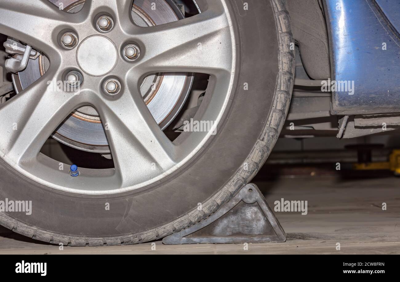 Car wheel on a car with a wheel stopper, close-up, wheel tuning disk ...