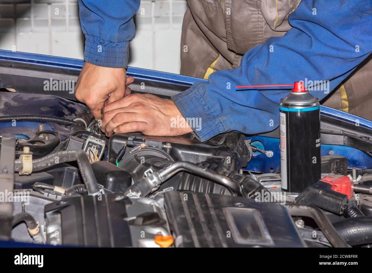 Repairman Working with dirty hands and uniform fixing car engine at ...