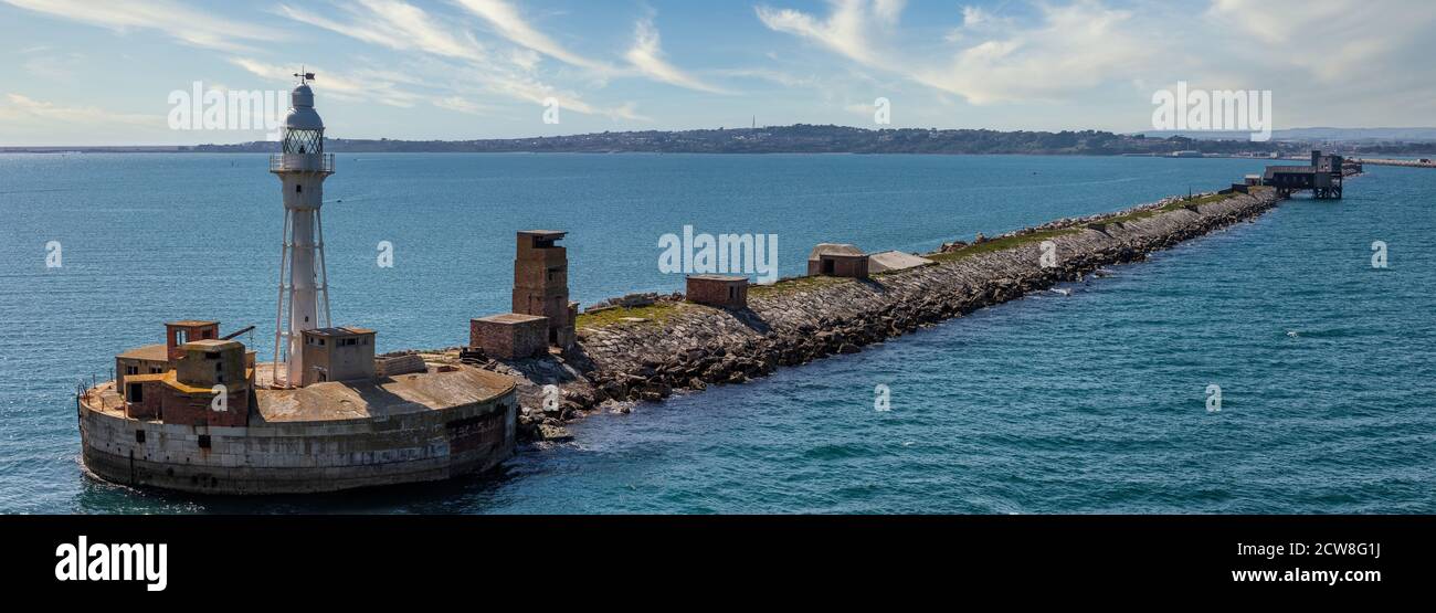 Lighthouse and water barrier at the entrance to the Portland harbour in ...