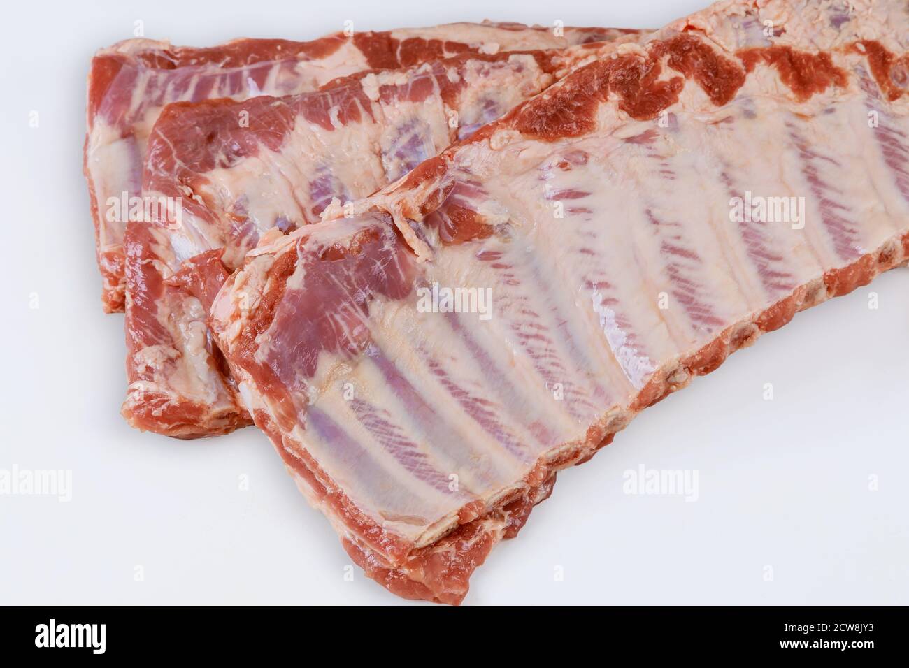 Fresh pork ribs isolated against on white background Stock Photo - Alamy