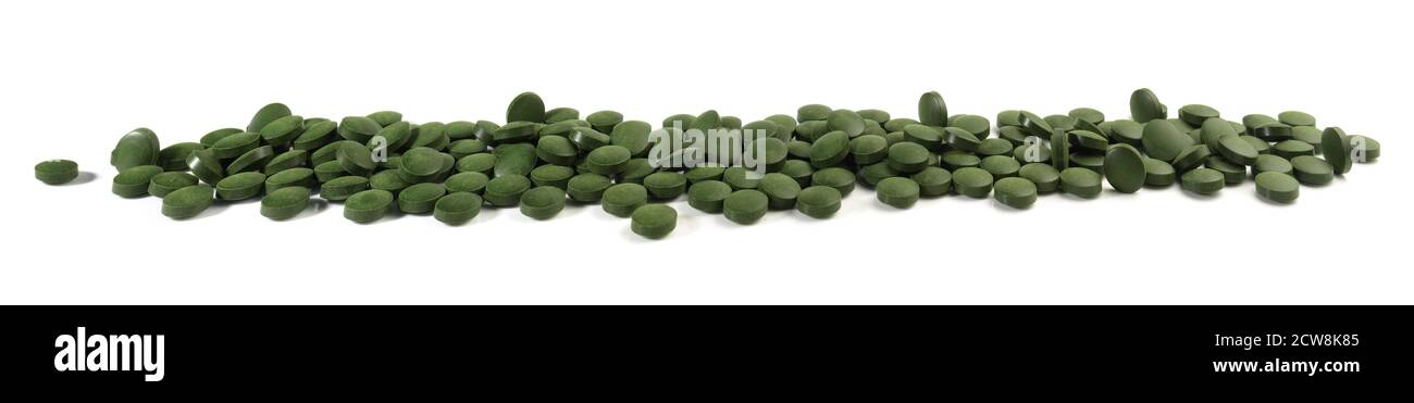 Chlorella Pills Panorama isolated on white Background Stock Photo - Alamy