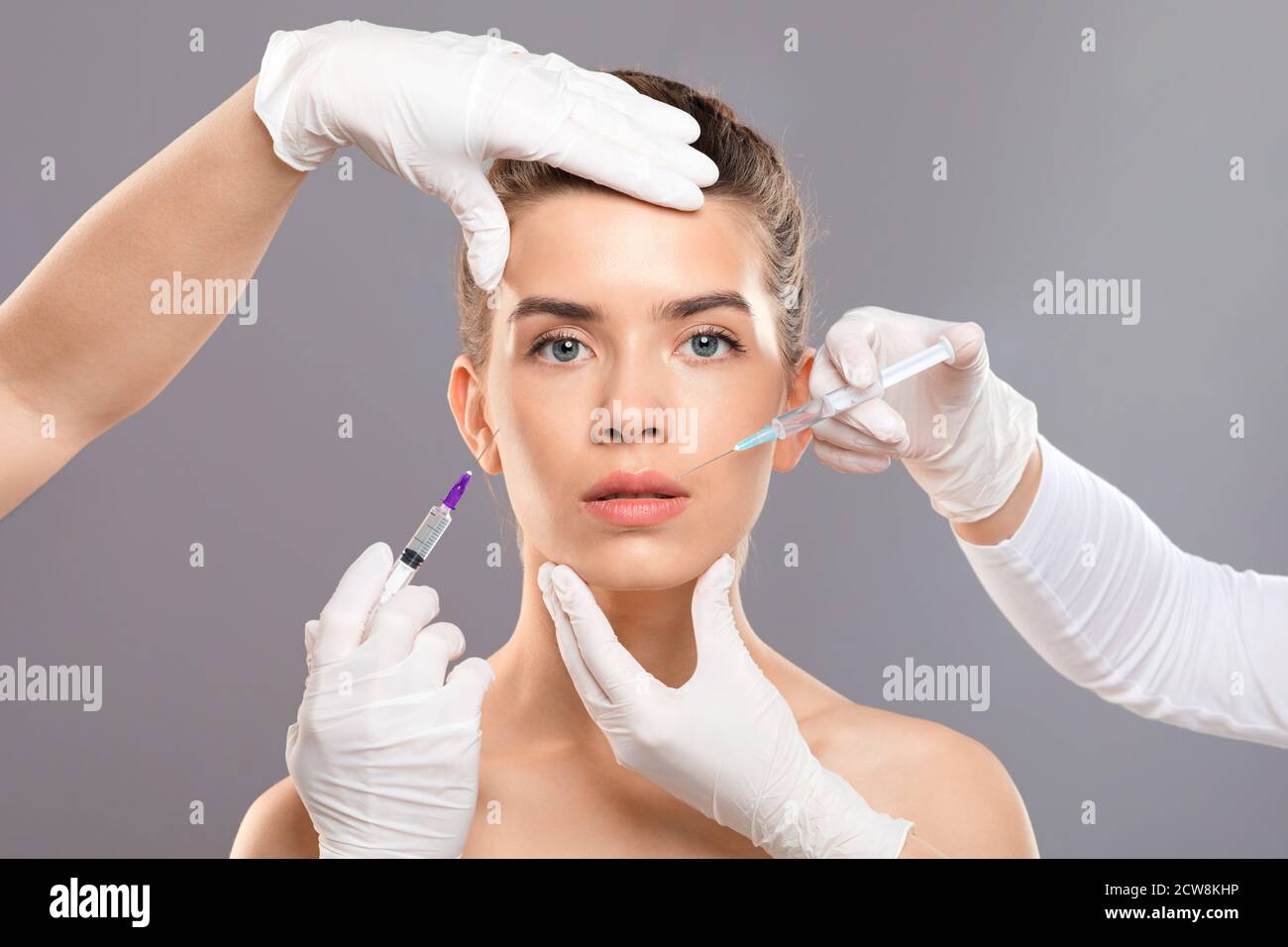 Beautitians making beauty injections for pretty young lady Stock Photo ...