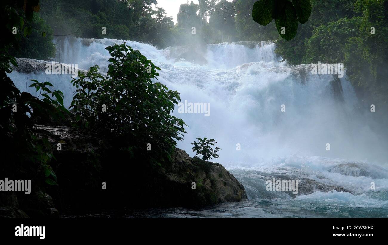 Cascade of Aliwagwag Falls in green forest. Waterfall in the tropical mountain jungle ...
