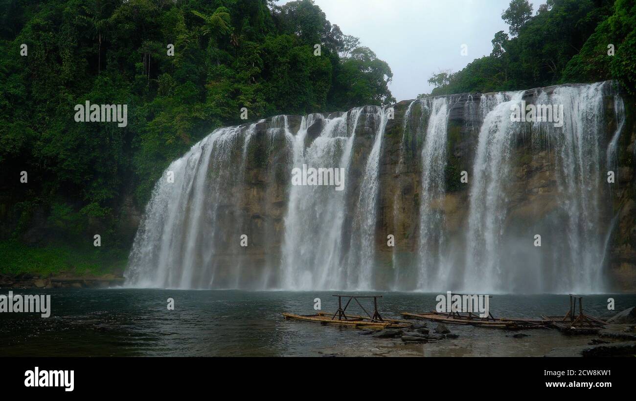 Beautiful waterfall in green forest. Tropical Tinuy-an Falls in ...