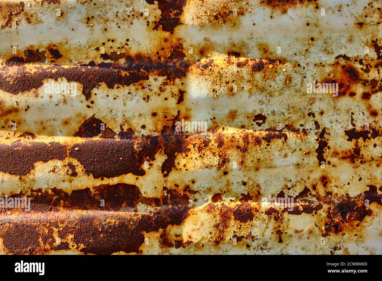 Rusty iron texture in soft sunlight; poor quality enamel coating ...
