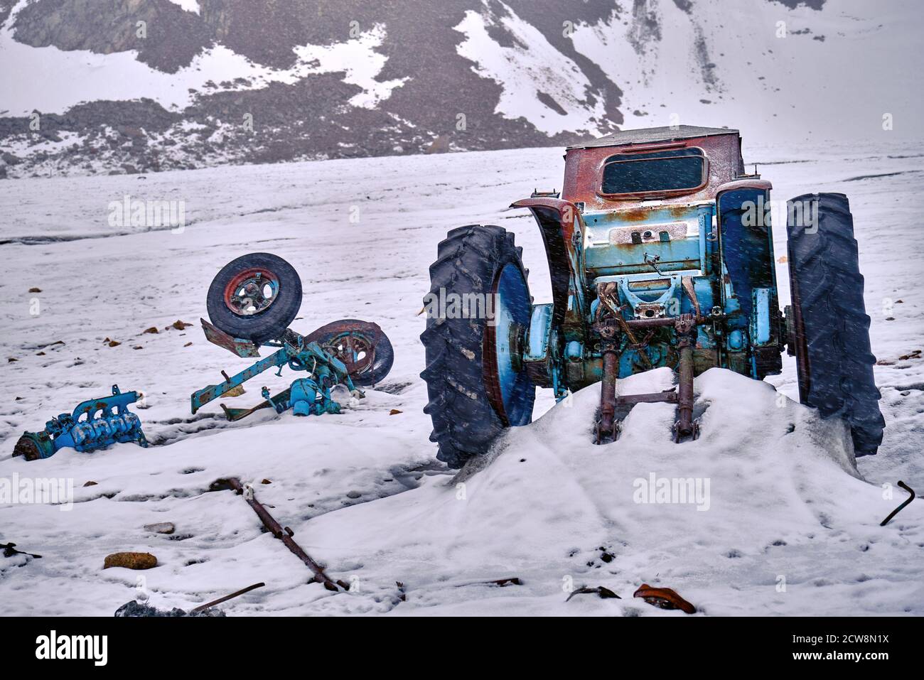 Disassembled parts of the old tractor as rubbish and pollution on a ...