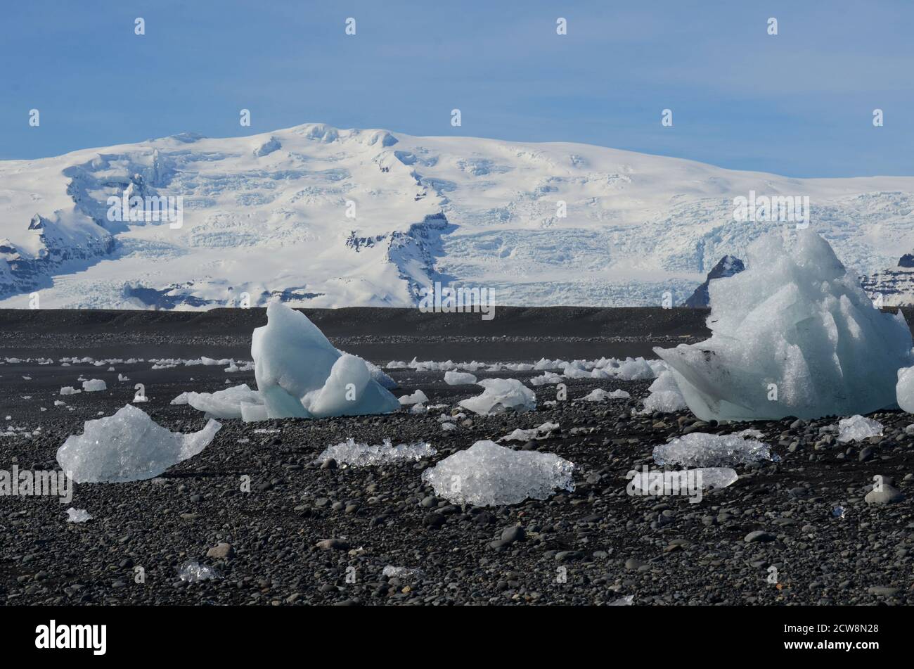Iceland's black sand beach with snow and ice Stock Photo - Alamy