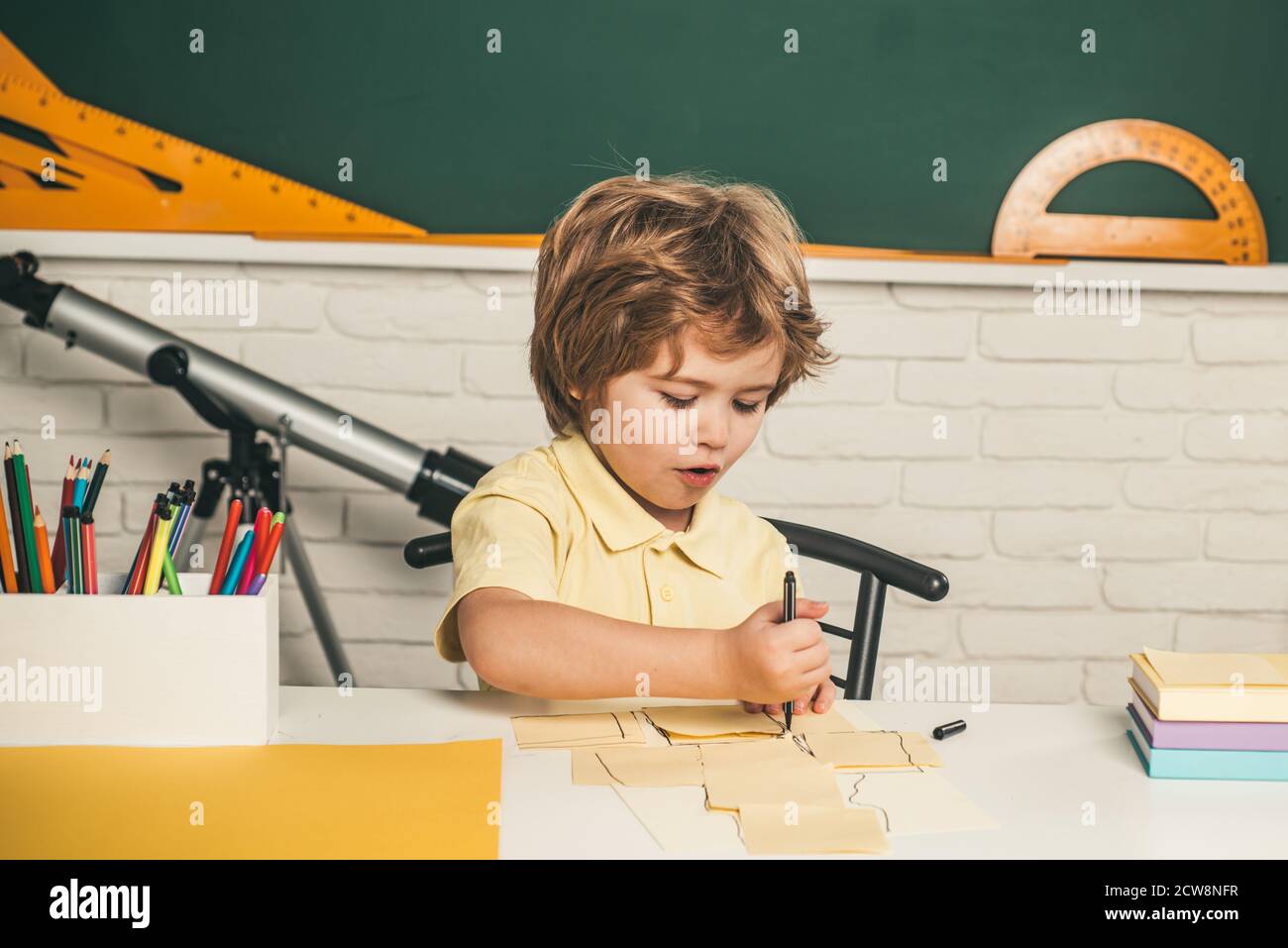 Schoolkid or preschooler learn. Cute pupil with funny face schooling ...
