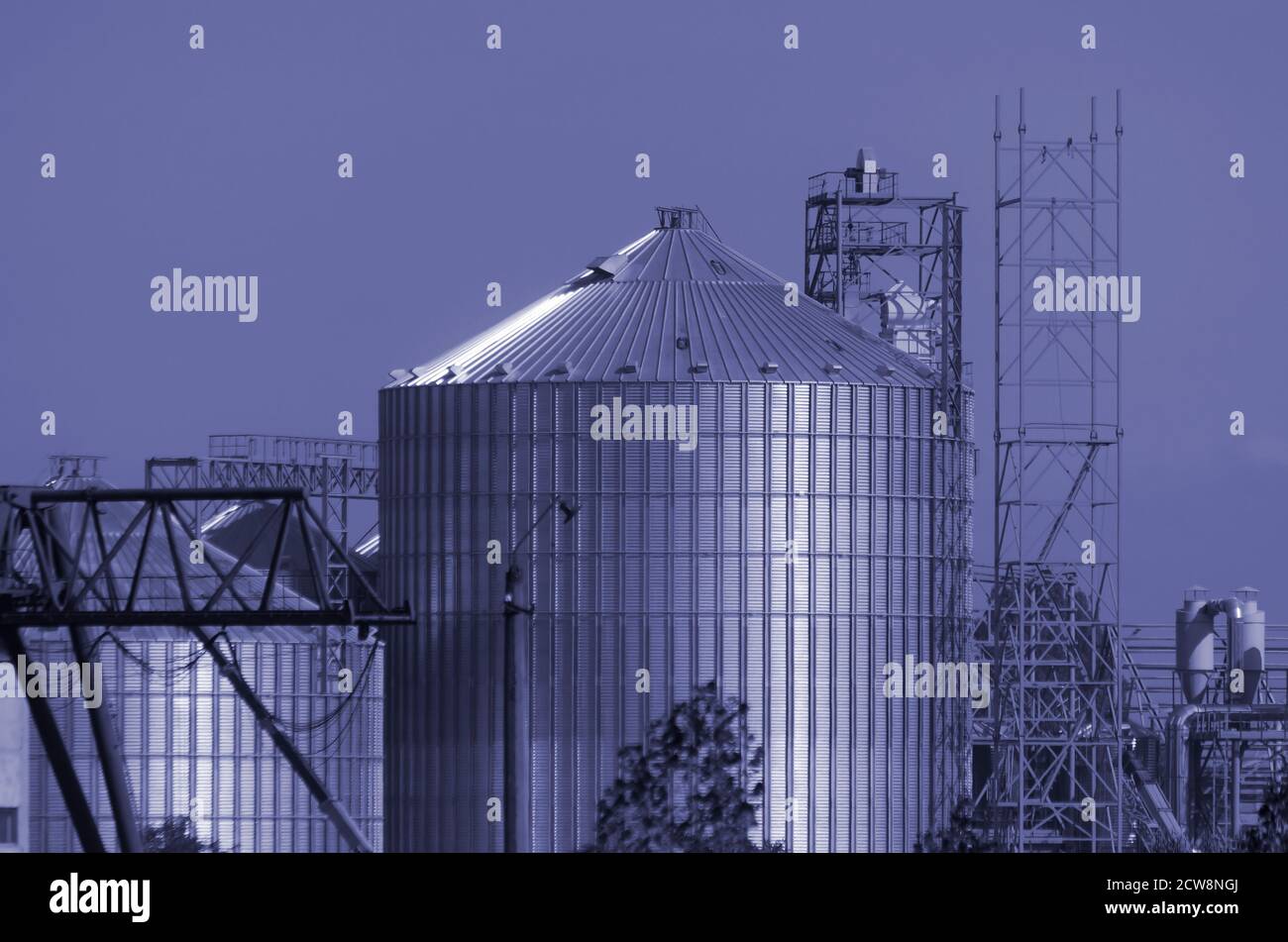 Construction of a modern grain terminal. Metal cylindrical silo and ...