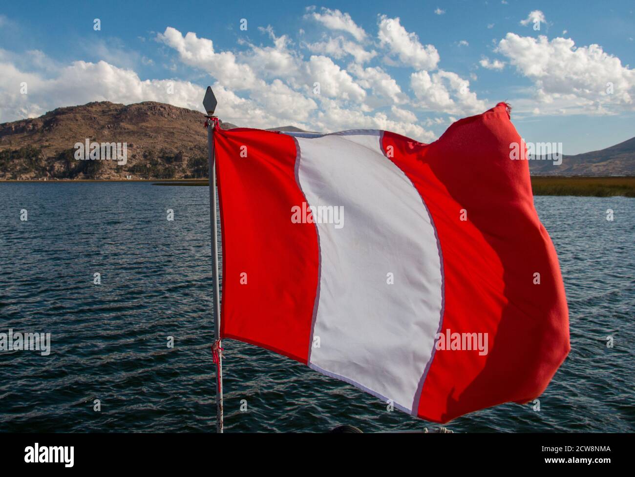 Peruvian Flag flying over Lake Titicaca, Puno, Peru Stock Photo - Alamy