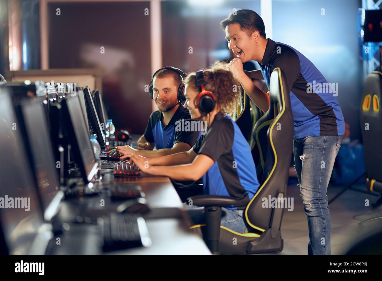 Celebrating success. Team of professional teenage cyber sport gamers ...