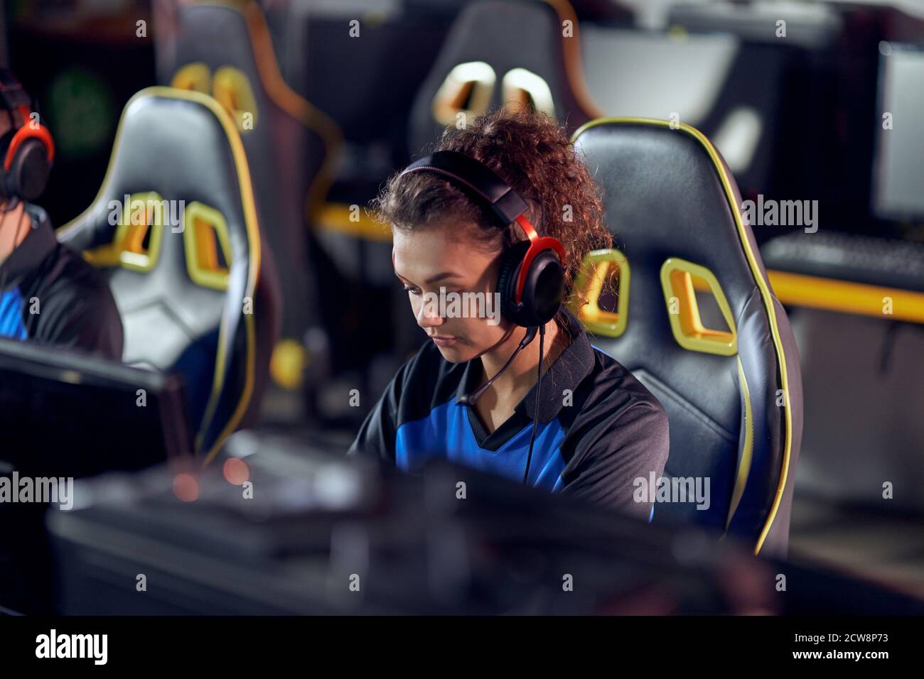 Play to win. Focused teenage mixed race girl, professional female gamer ...