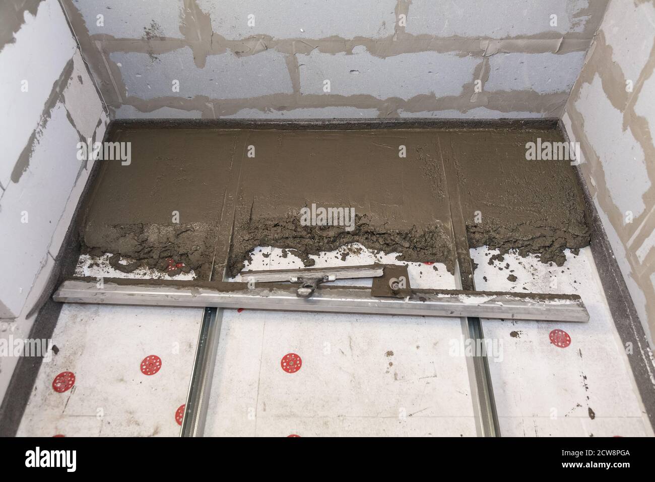 plastering concrete on the floor at the house construction Stock Photo ...