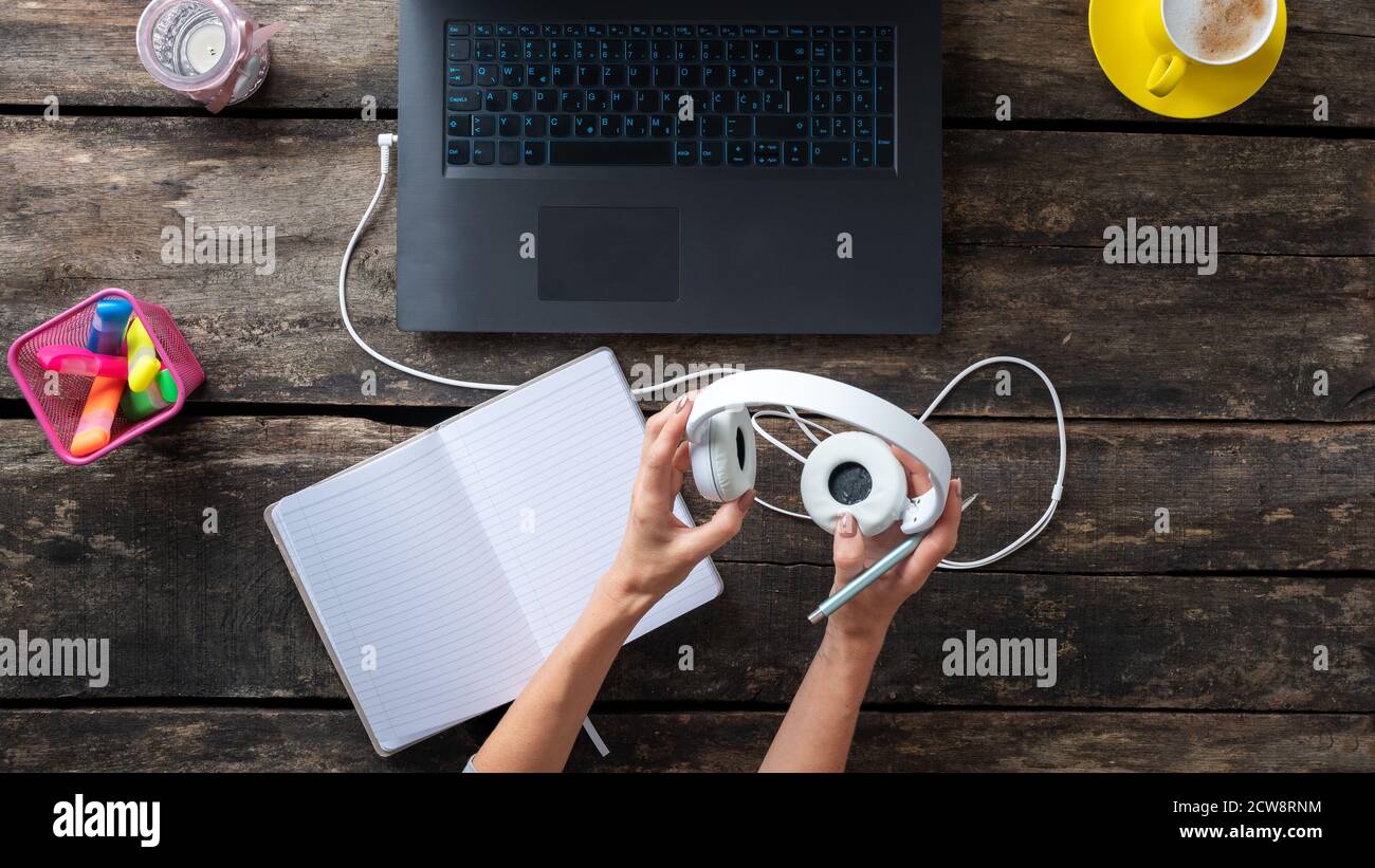 E learning conceptual image - top view of female hands holding white ...