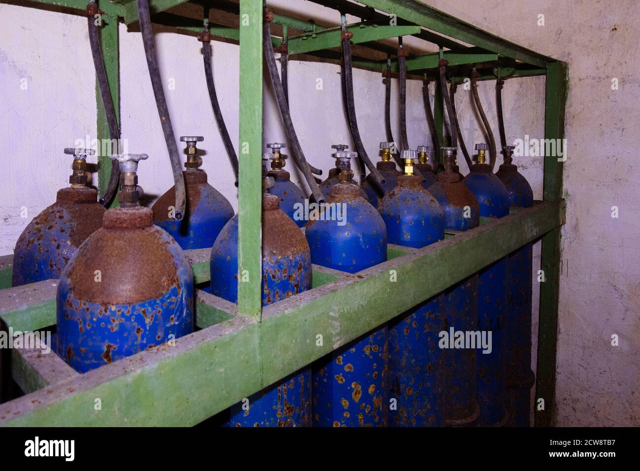 Old rusty bundle of blue gas cylinders Stock Photo - Alamy