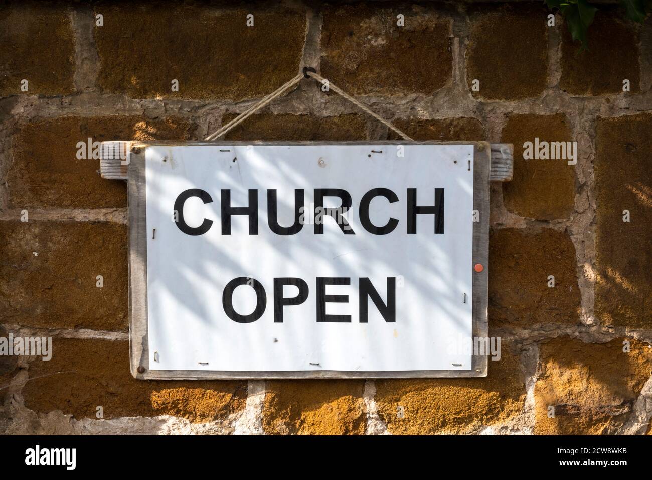 A Church Open sign outside St Andrew's church, Ringstead. Churches are ...