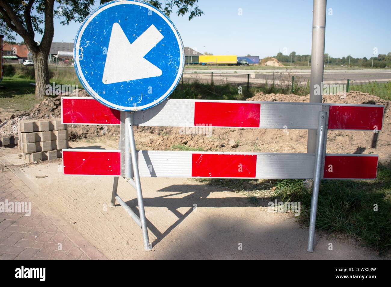 Barriers with blue arrow sign for roadworks Stock Photo - Alamy