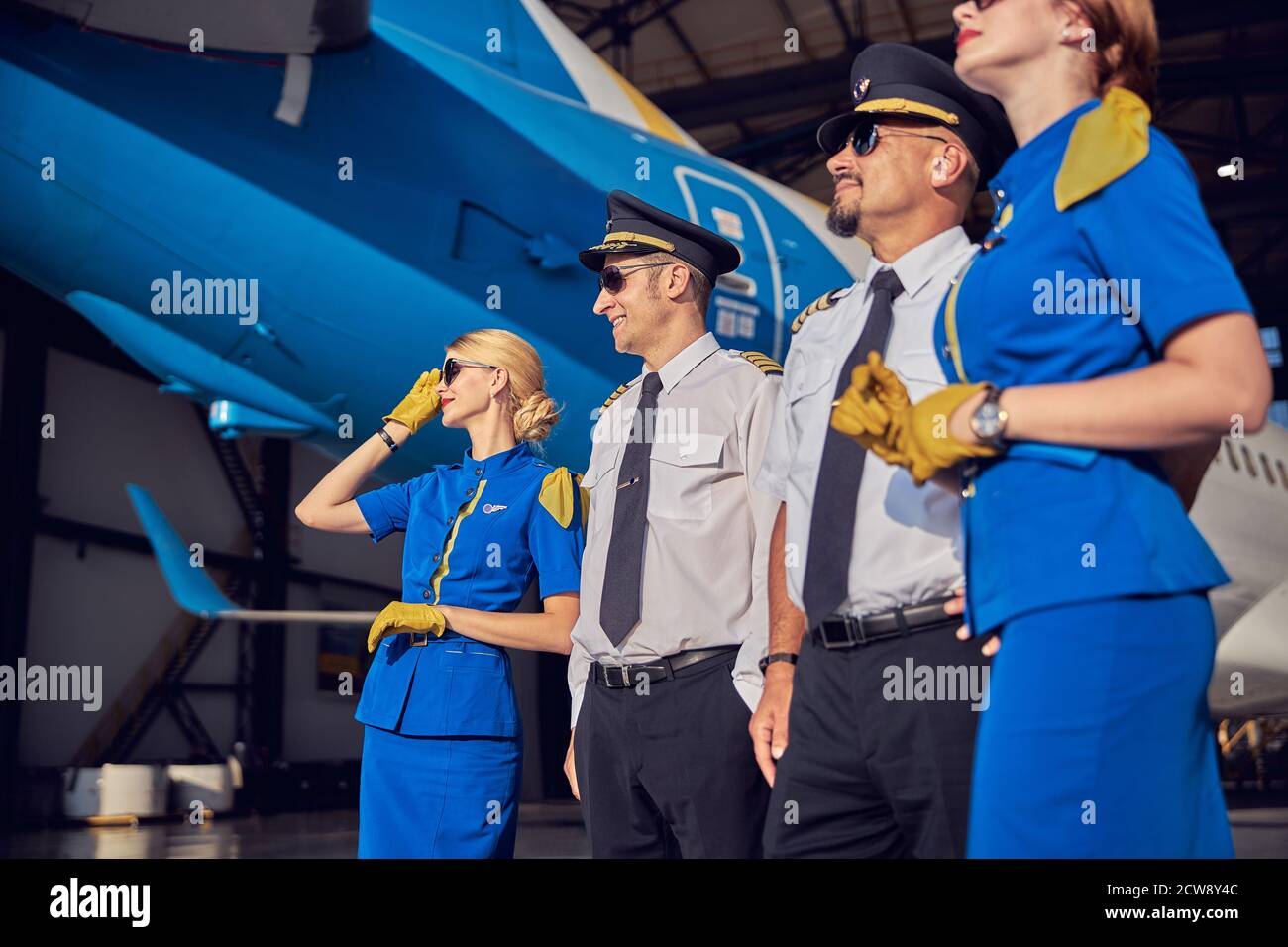 Adult Caucasian pilots and females air hostesses spending time in the ...