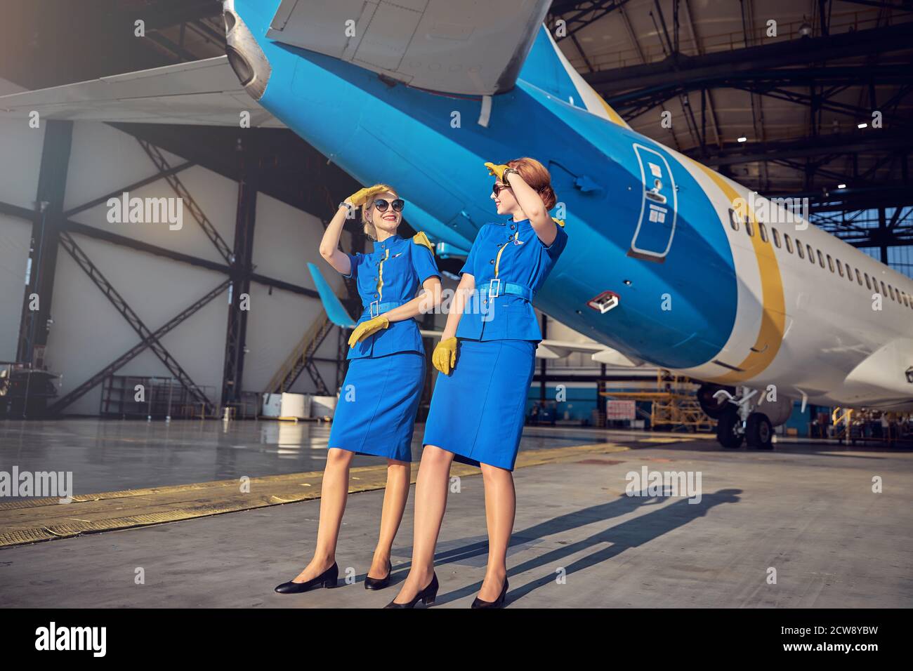 Happy smiling air hostess having fun in the outdoors after long flight ...