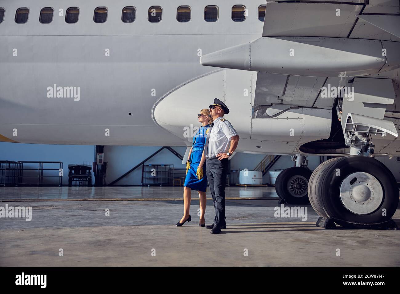 Captain with air hostess enjoying good weather in the airport Stock ...