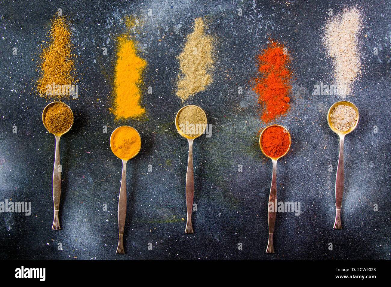 variation of spices on the vintage silver spoons, all spices on the ...