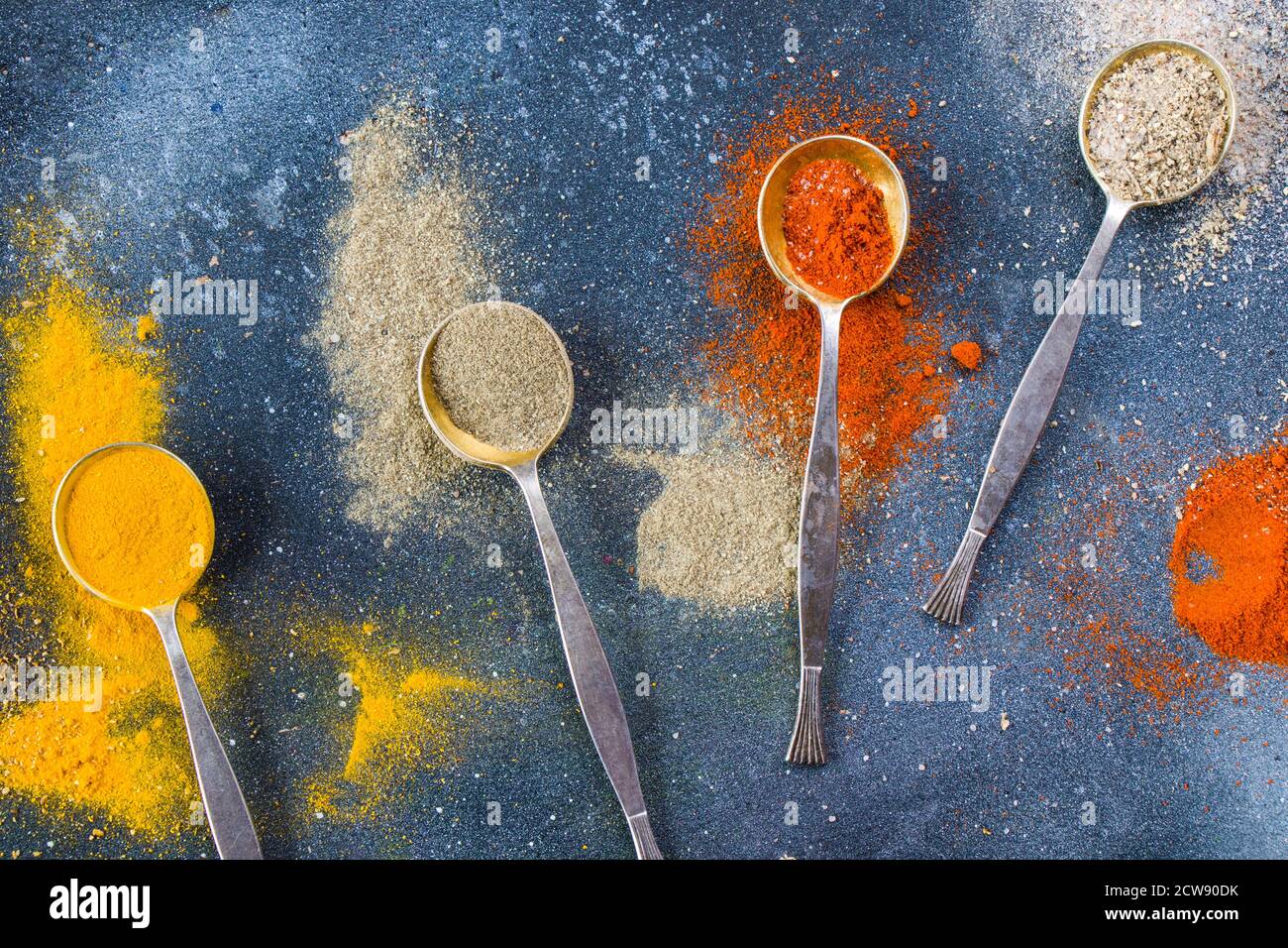 variation of spices on the vintage silver spoons, all spices on the ...