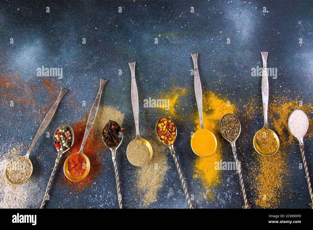variation of spices on the vintage silver spoons, all spices on the ...
