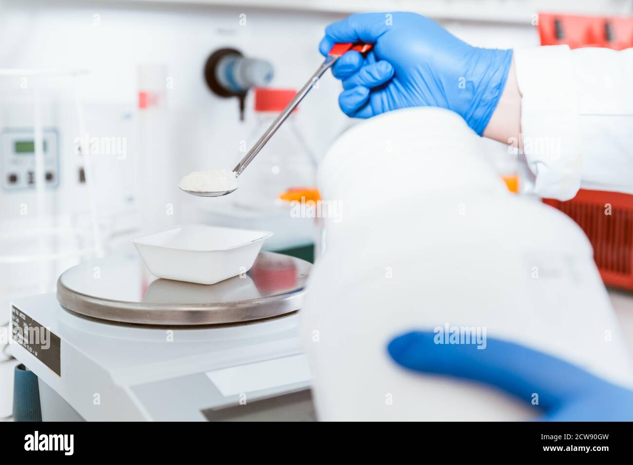 Pharmacist pouring white powdered chemical Stock Photo - Alamy
