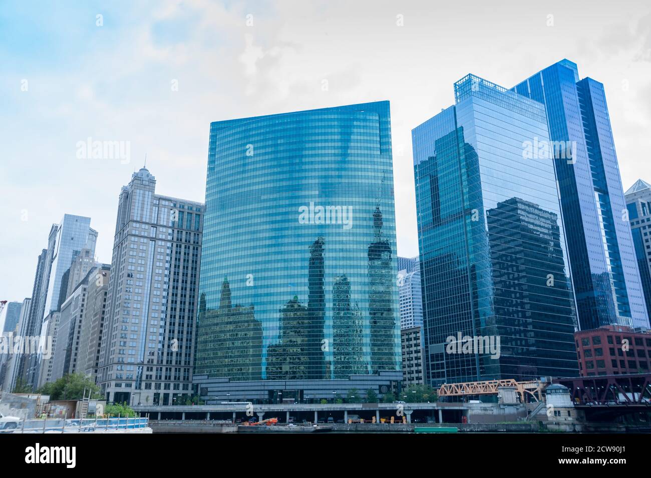 Chicago commercial high-rise skyline rising above river with glass ...