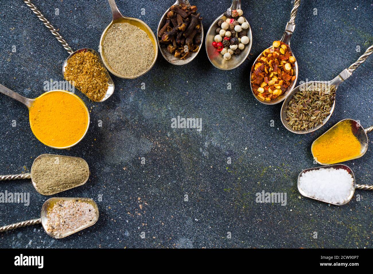 variation of spices on the vintage silver spoons, all spices on the ...