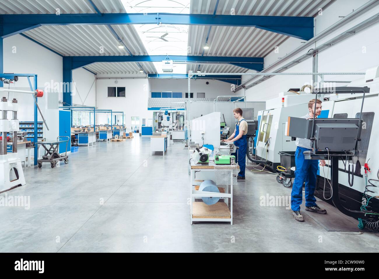 Workers working on the factory floor in well lit hall Stock Photo - Alamy